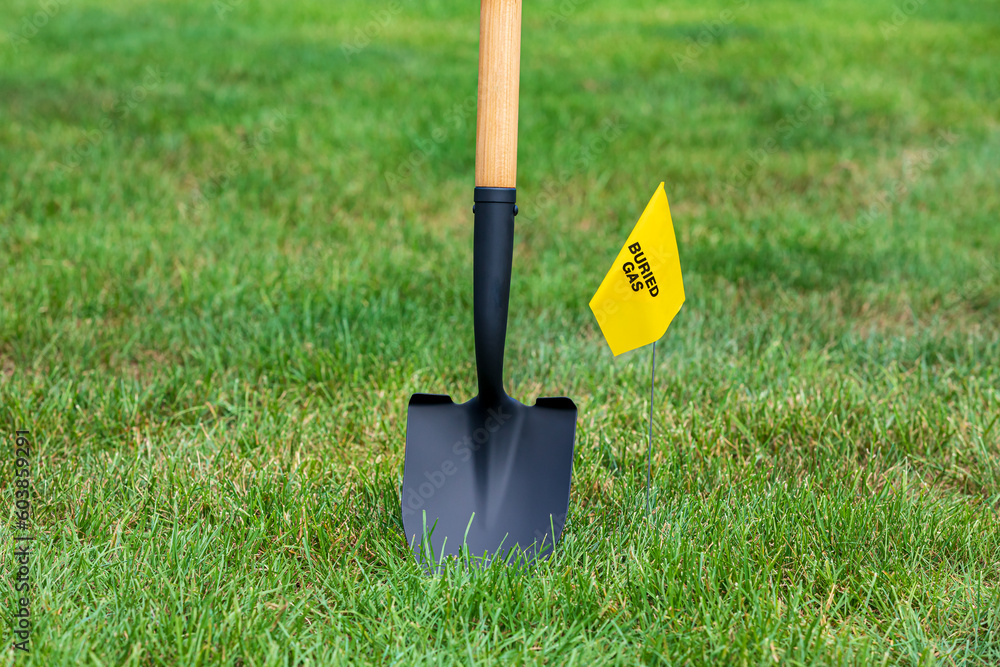 Natural gas utility warning flag with shovel. Notify utility locate ...
