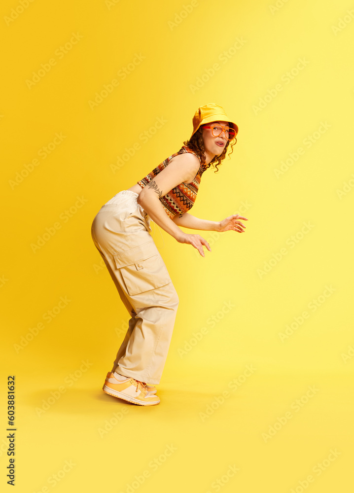 Full-length portrait of funny young girl in panama, pants and top ...