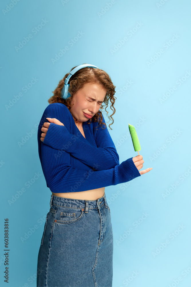 Brrr. Cold. Portrait of young girl in blue top, jeans skirt and ...
