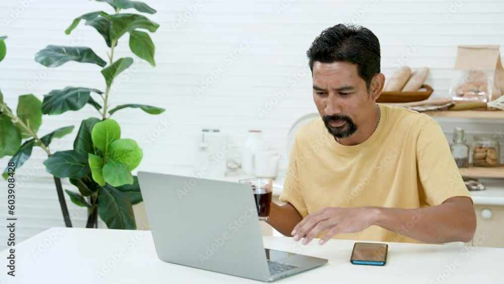 Close-up Asian man sitting and drinking coffee sit work during working ...
