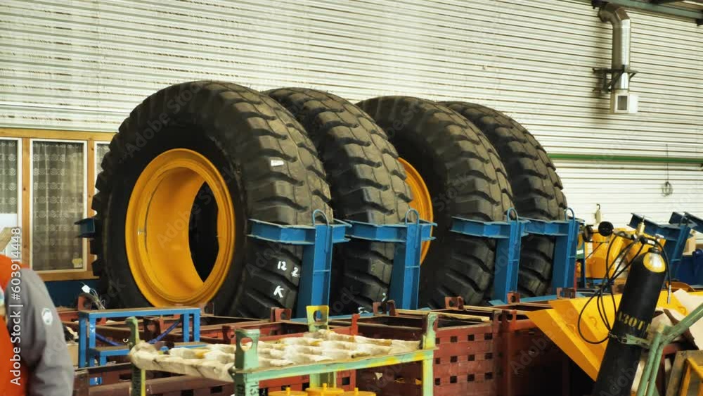 Wheels and tyres in a dump truck assembly plant. Quarry truck assembly ...