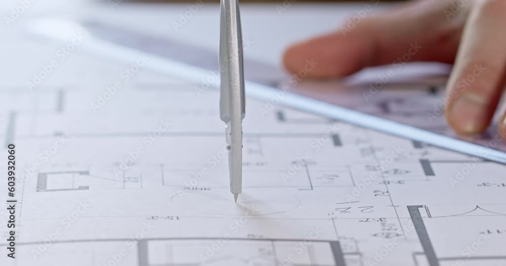 Engineer hands draw circle using dividers on floor plan of building ...