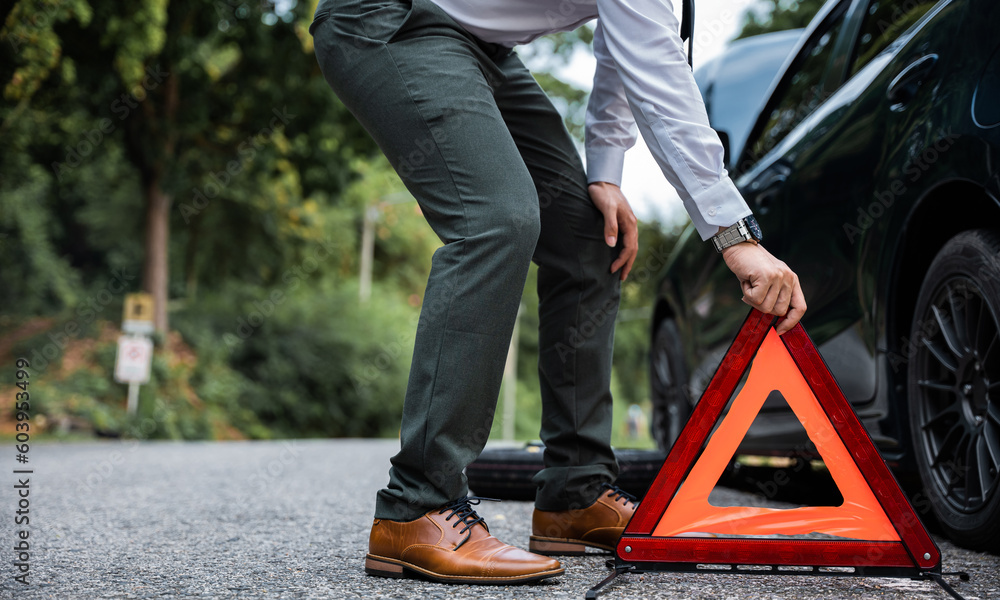 Asian businessman stranded with broken car and red warning triangle on ...