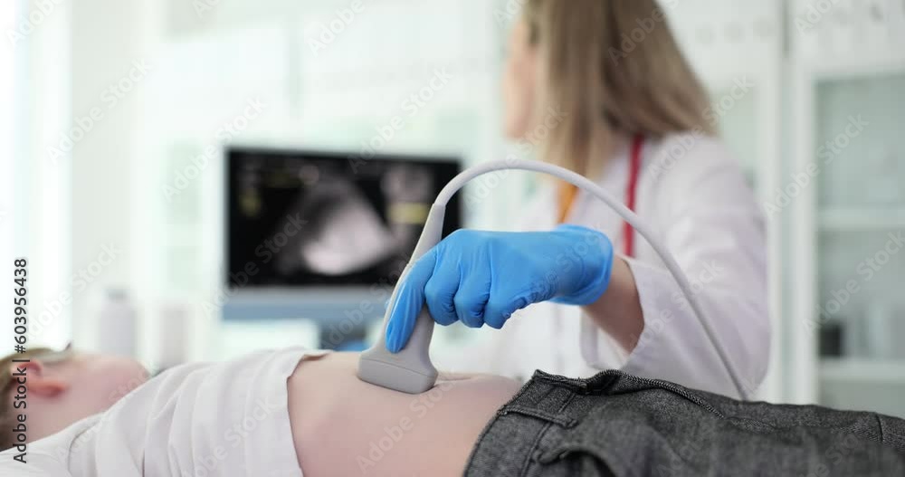 Ultrasound examination of child doctor makes scan of the abdomen of ...