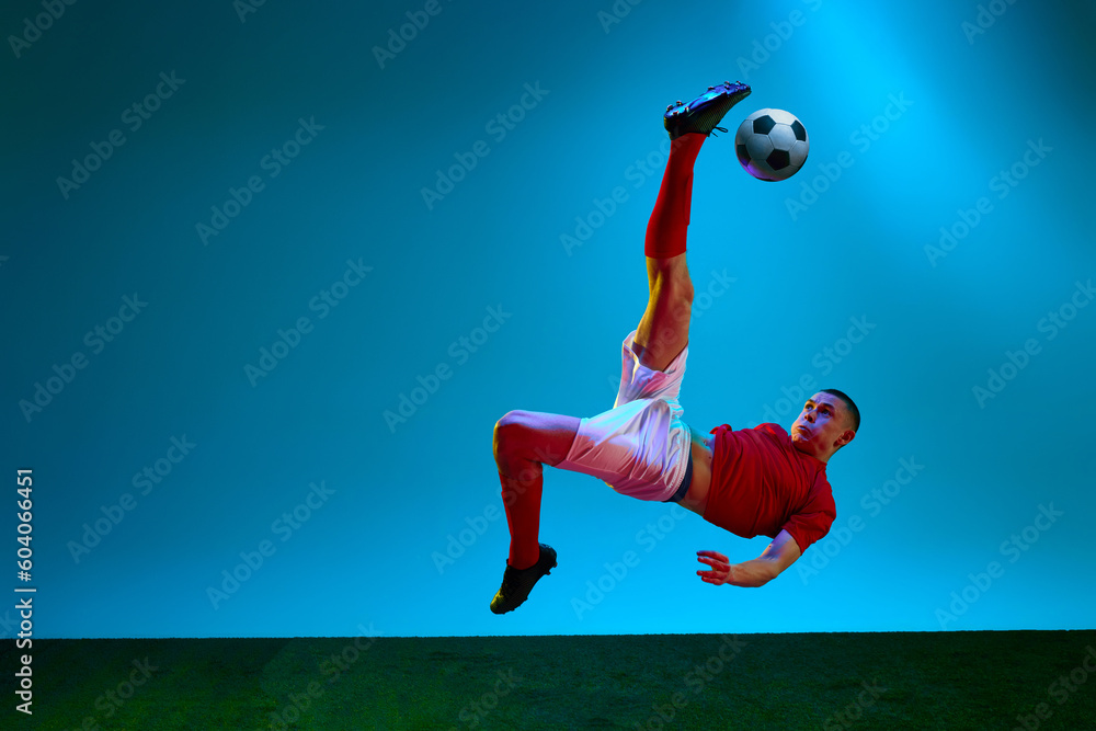 Dynamic portrait with professional man, football player in sportswear ...