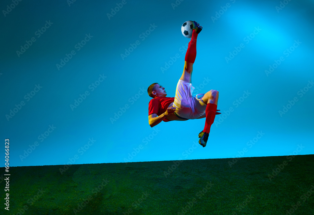 Professional man, football player in sports team uniform falling down ...