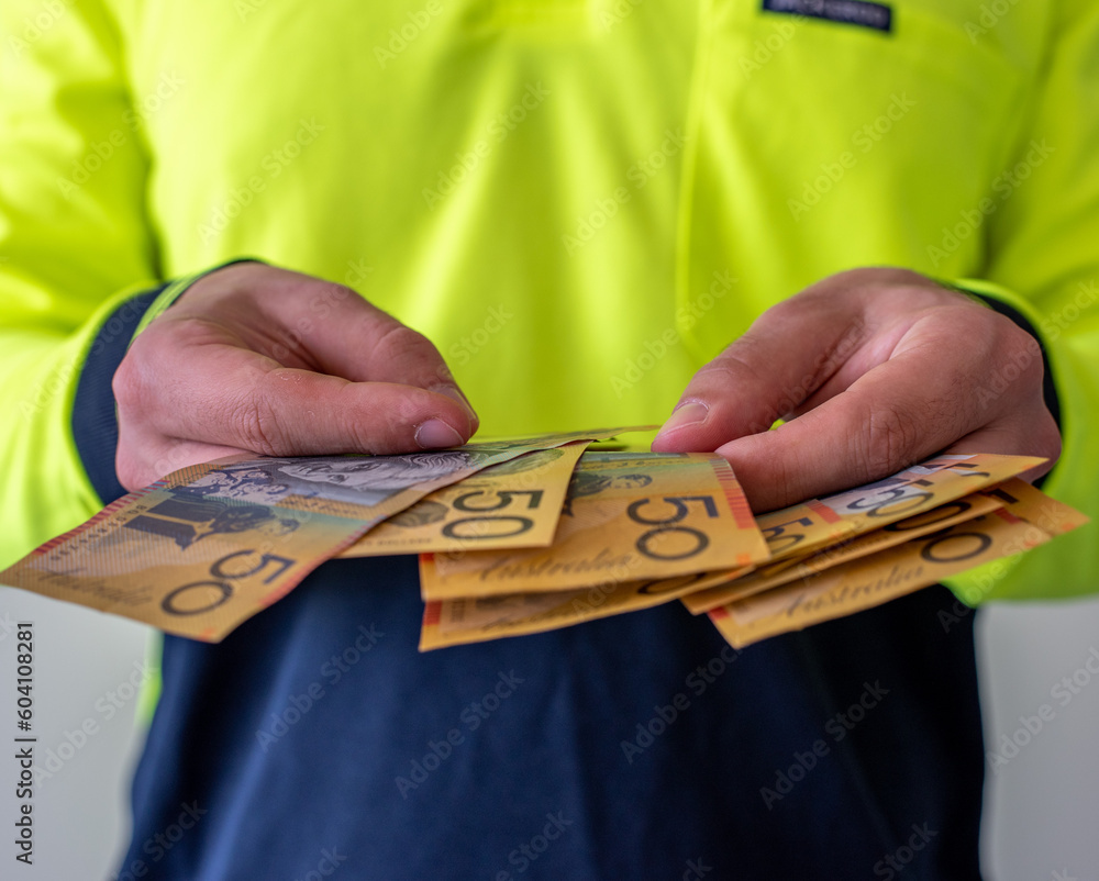 Tradesman receiving wages from work, dressed in a suit and holding ...