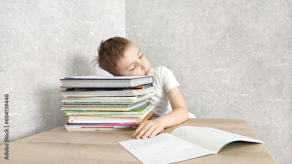 Tired boy with ADHD is bored in class, distracted, does not want to do ...