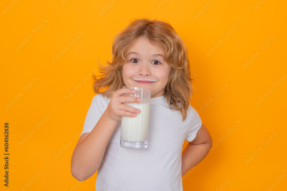 Child with glass of milk on studio yellow background. Kid with milk ...
