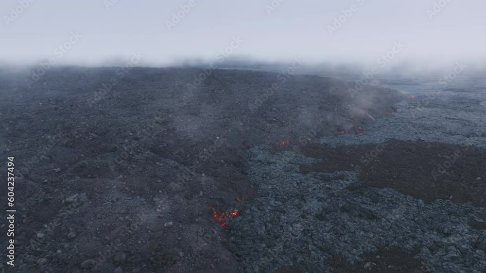 Epic aerial shot on drone of red hot lava flowing and freezing with ...