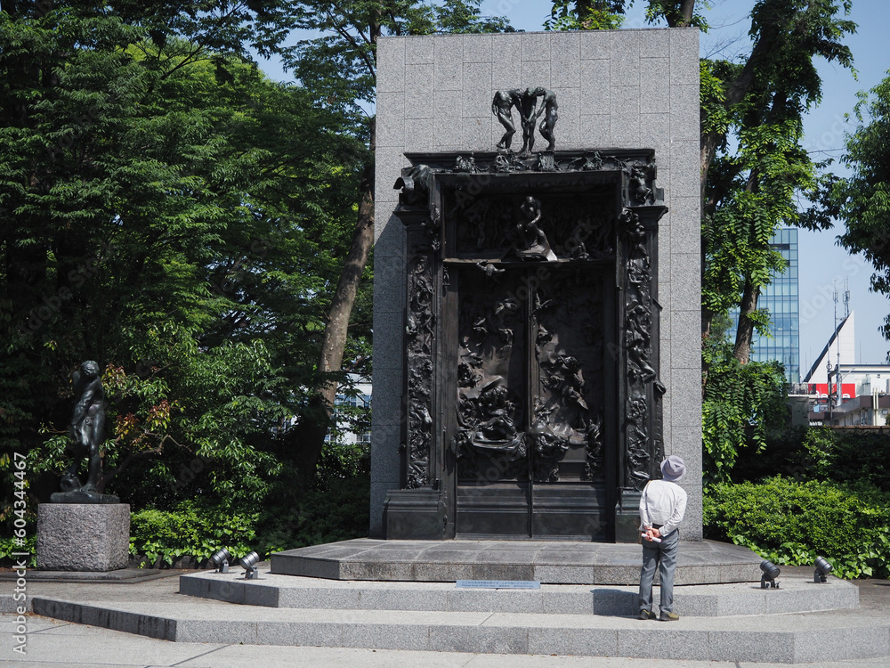TOKYO, JAPAN - May 17, 2023: A visitor looks at Rodin's Gates of Hell ...