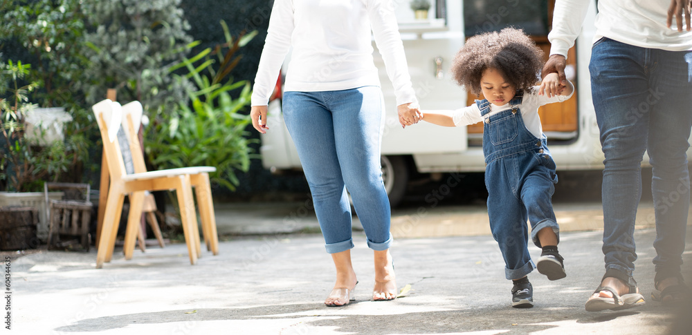 Smiling biracial child and family have fun together outdoors. Portrait ...