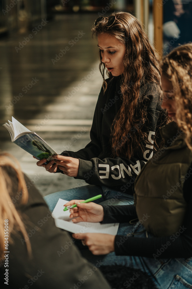 Stunning brunette girl reading story from the book out loud to her ...