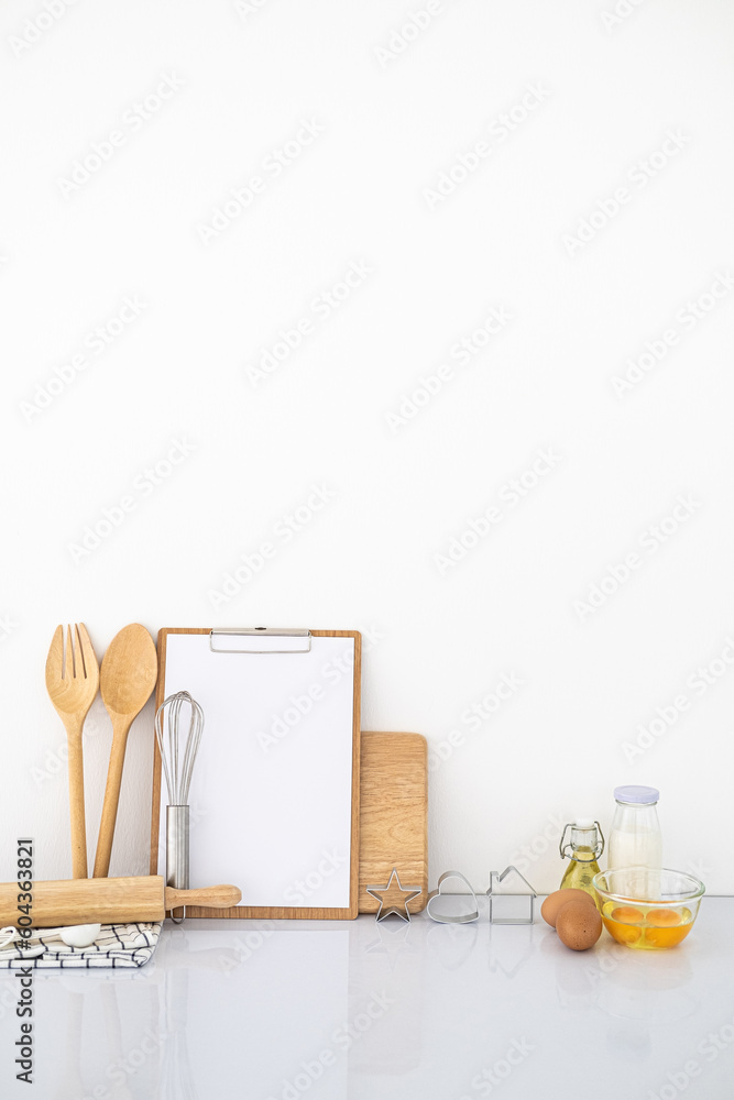 Vertical blank cook book and wooden kitchen tool on white table and ...