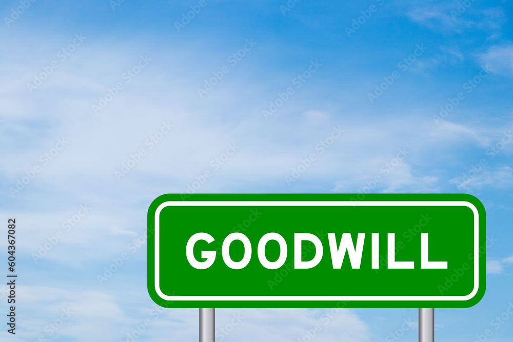Green color transportation sign with word goodwill on blue sky with ...