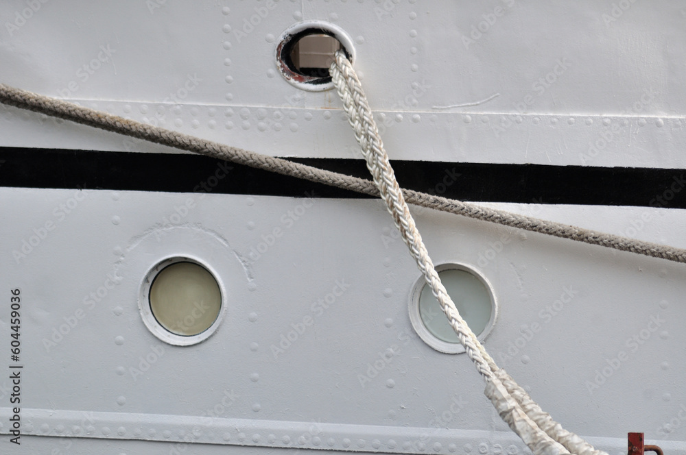 Foto de Part of a white ship's hull with a hole and two round windows ...