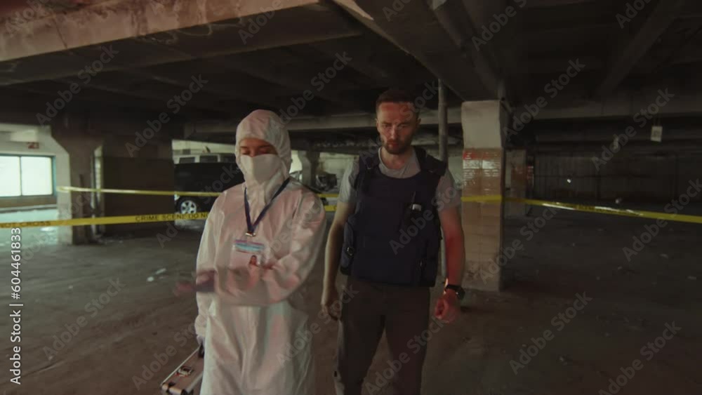 Medium full shot of Caucasian male detective and forensic expert in ...