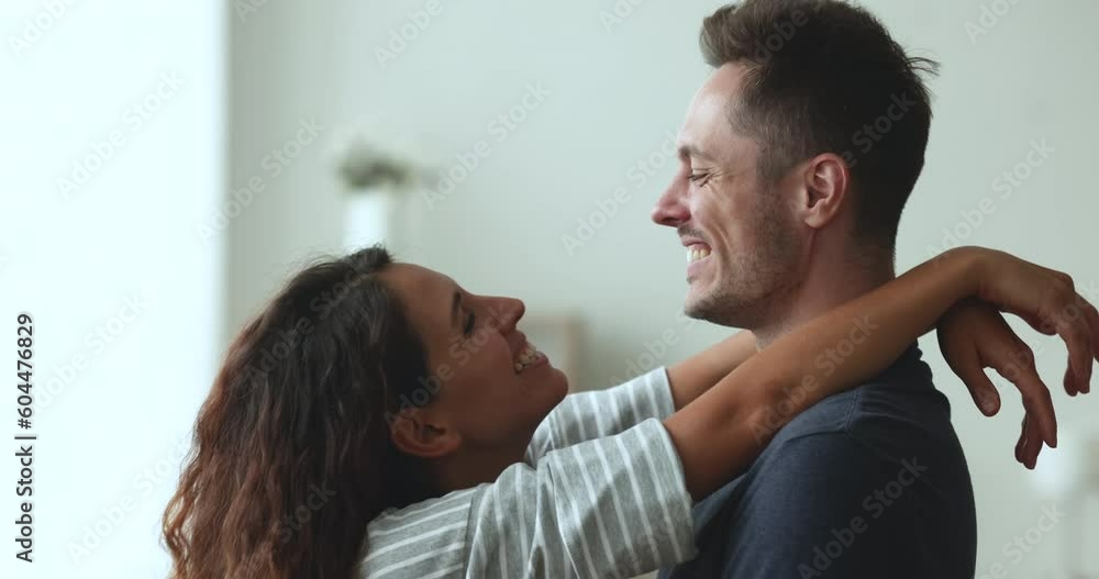 Close up of beautiful enamoured Hispanic couple hugging, dance or ...