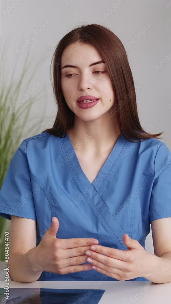Vertical video. Female doctor. Medical consultation. Serious woman ...