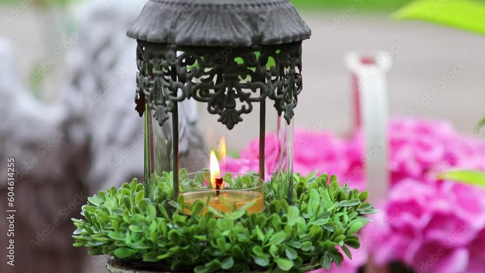Burning grave candle macro with blurred background shows religious ...