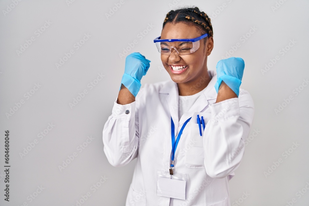 African american woman with braids wearing scientist robe very happy ...