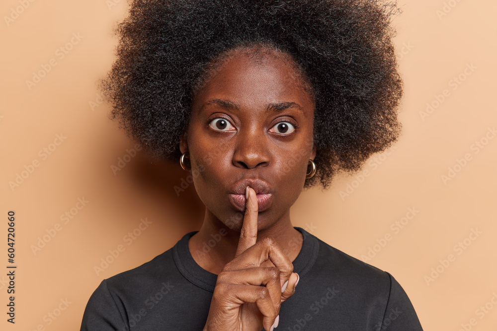 Secrecy and conspiracy concept. Mysterious dark skinned young woman ...