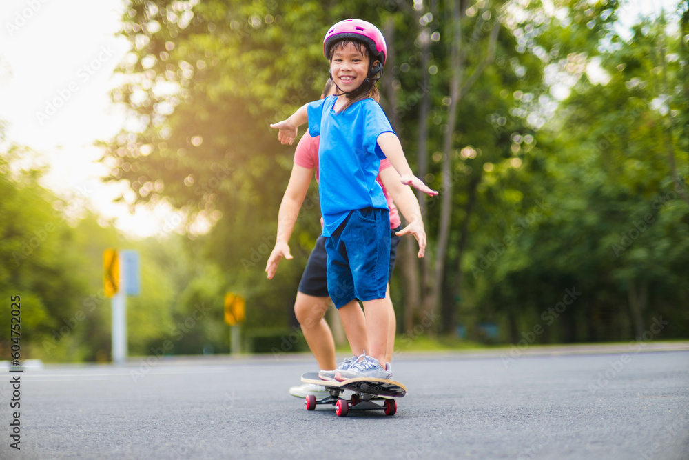 Active little girl and mom enjoy skateboarding. Cute little girl ...