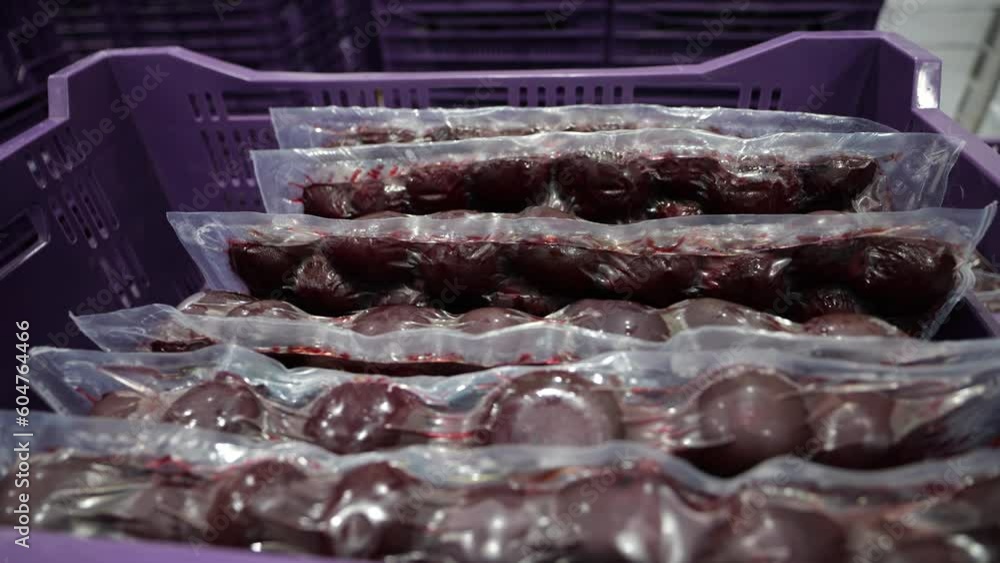 Packaged vegetables in storage boxes in food factory, beets in air ...