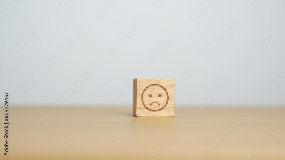 Hand choosing unhappy angry face from Emotion block. customer review ...