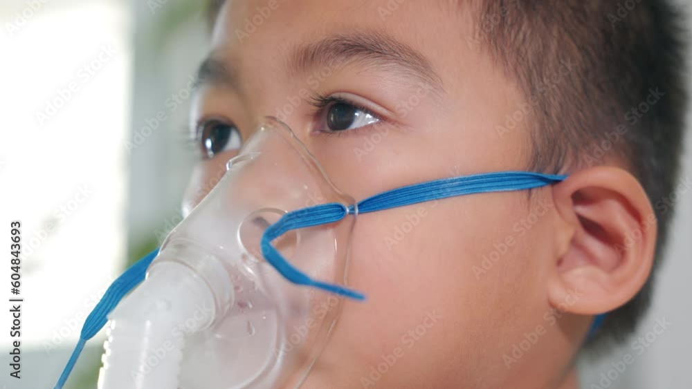 Asian Child using nebulizer mask equipment alone have smoke, Kid boy ...