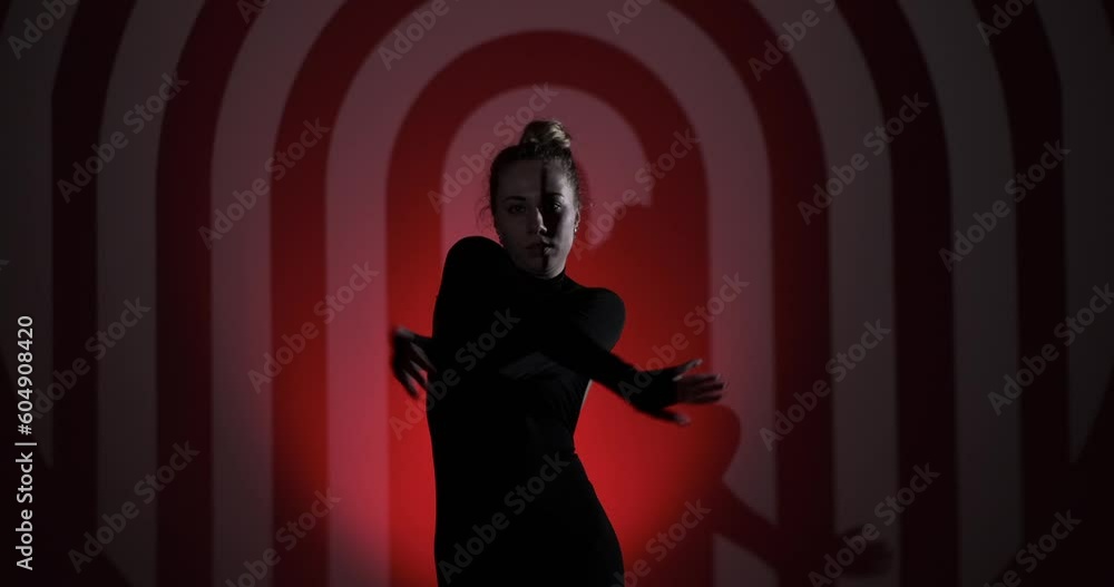 Against a vibrant red background with abstract figures, a curly-haired ...