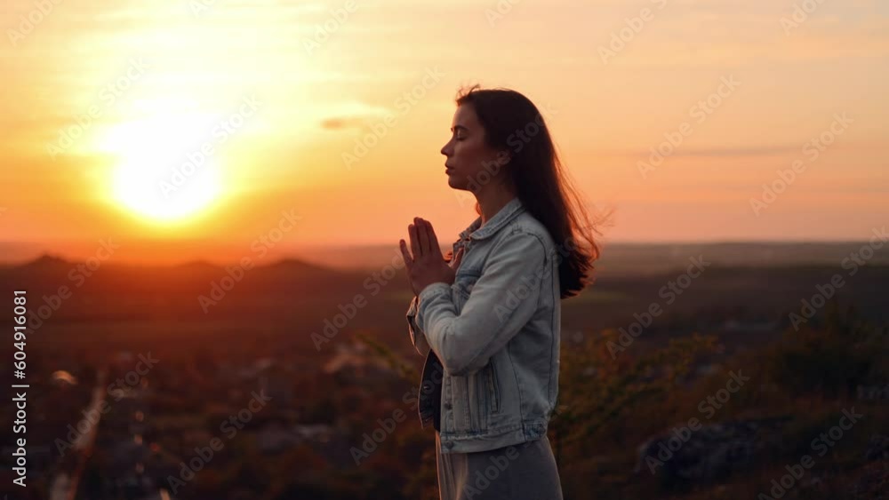 Girl folded hands in prayer silhouette at sunset. woman praying ...