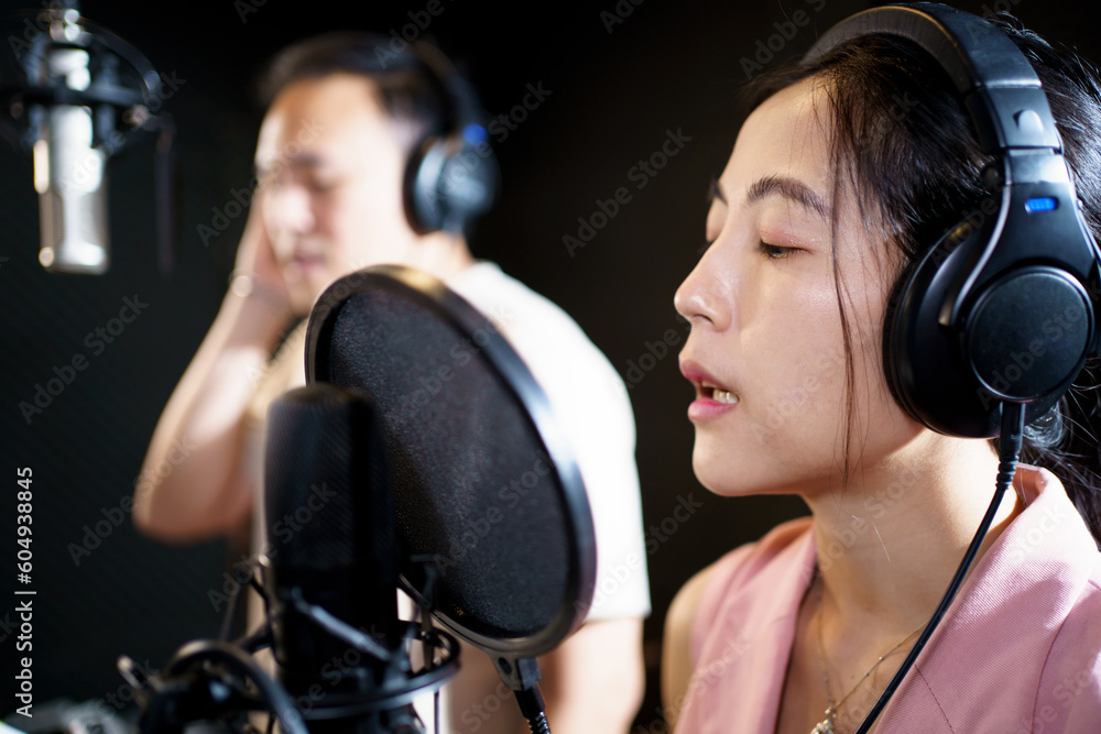 Asian professional singers recording in audio recording studio ...