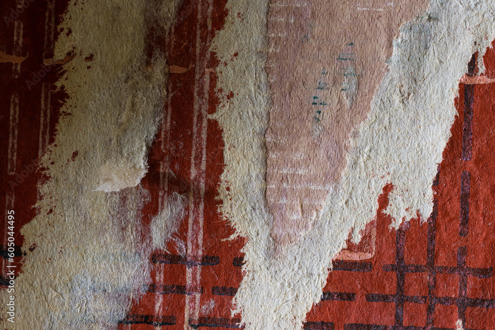 Torn old faded paper wallpaper with a retro pattern. Tattered scraps of ...
