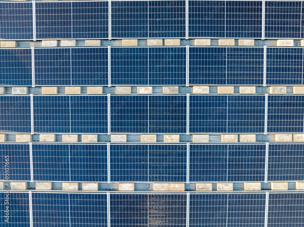 Aerial photo solar panels install on a flat commercial, school ...