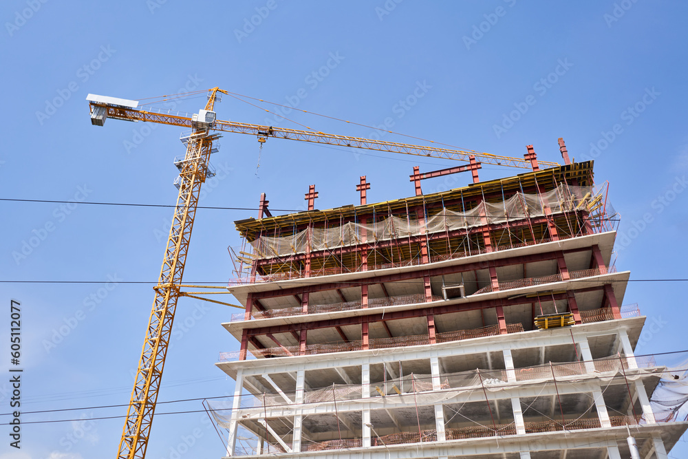 Tower cranes constructing a new residential build. Hydraulic luffing ...