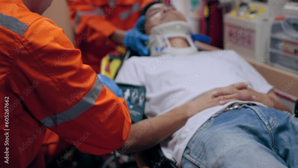 Asian emergency medical technician (EMT) or paramedic measuring blood ... Asian emergency medical technician (EMT) or paramedic measuring blood ...