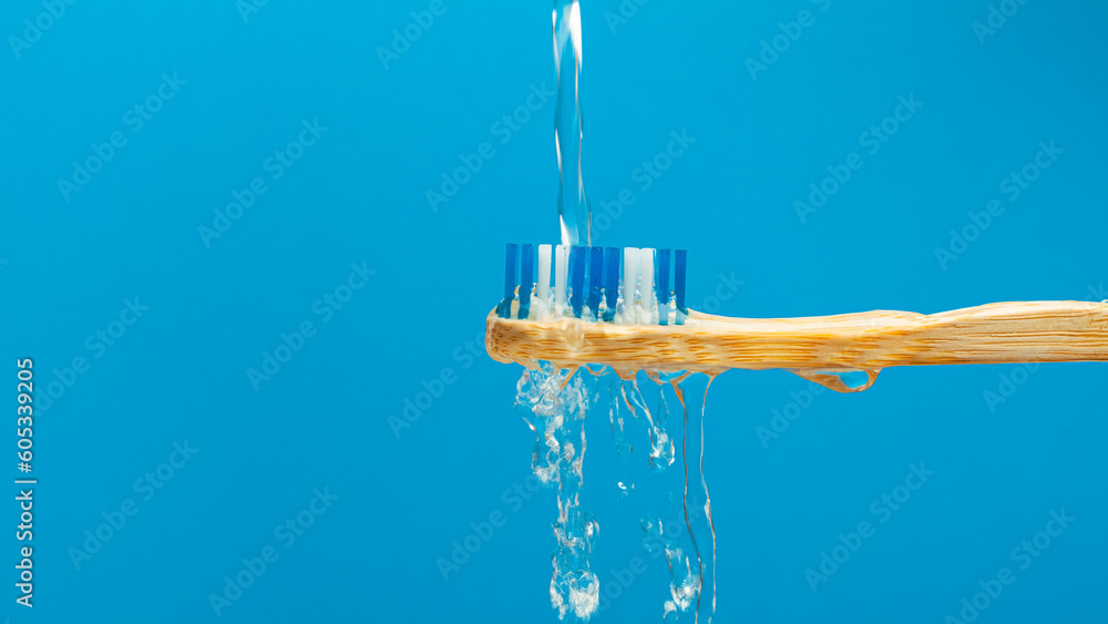 bamboo toothbrush water splash on blue background Stock Photo | Adobe Stock