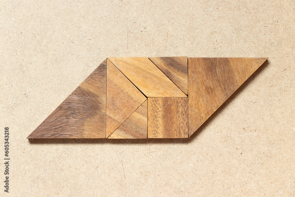 Wooden tangram in parallelogram shape on wood background Stock Photo ...