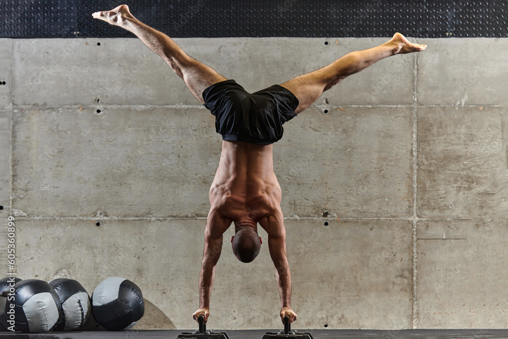 A muscular man in a handstand position, showcasing his exceptional ...