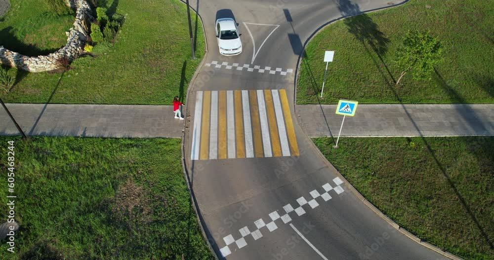 The driver on the car gives way at the pedestrian crossing, aerial view ...
