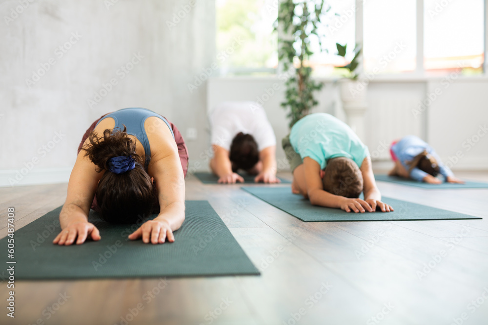 At home, parents with preschool children do yoga. Parents and children ...