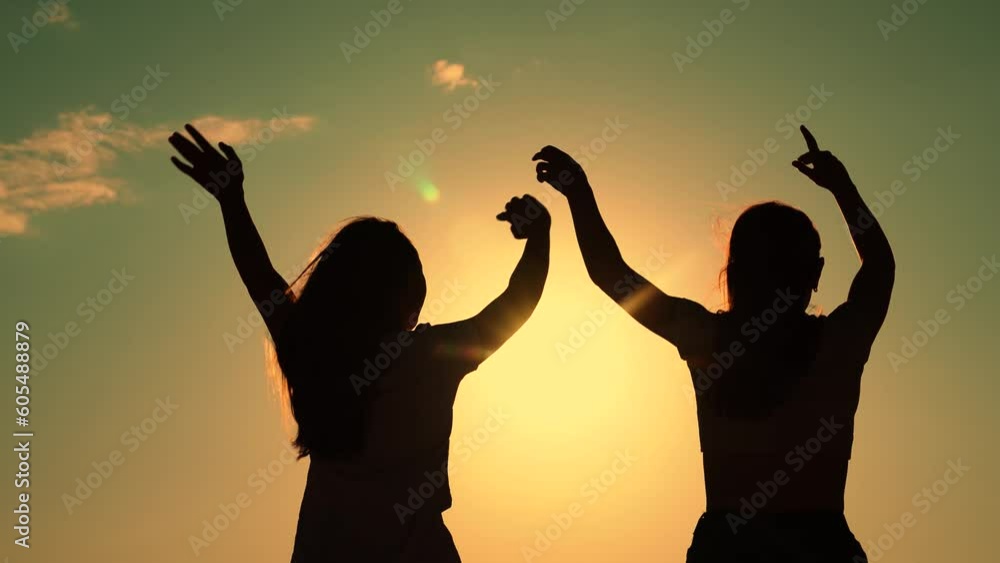 Free girls dance merrily on summer evening, sun. Group of young people ...