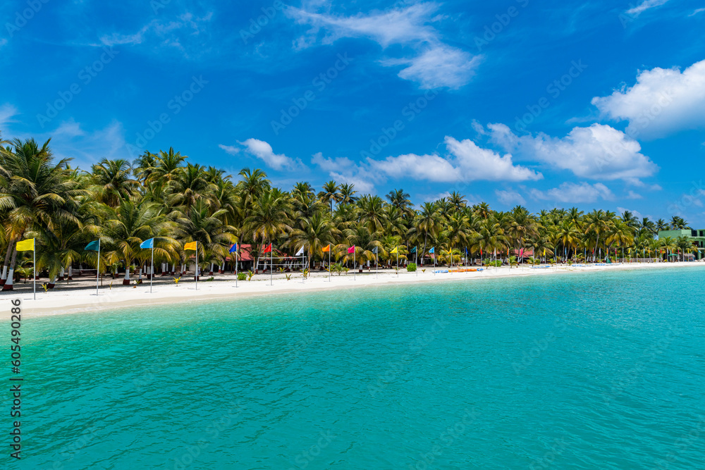 White sand beach with many flags, Bangaram island, Lakshadweep ...