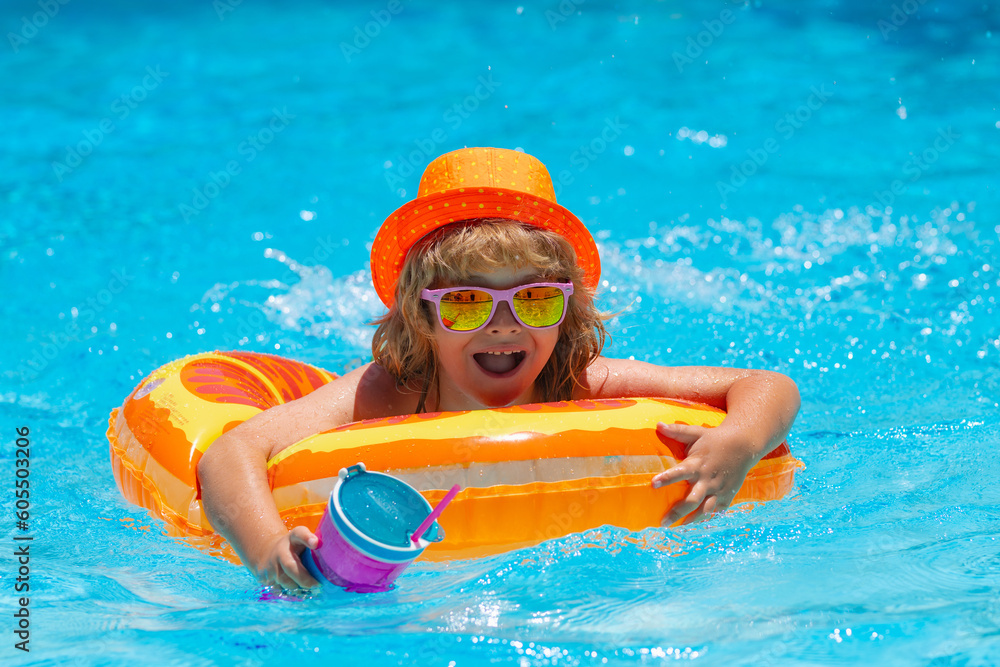 Kid boy swimming in pool play with floating ring. Smiling cute kid in ...