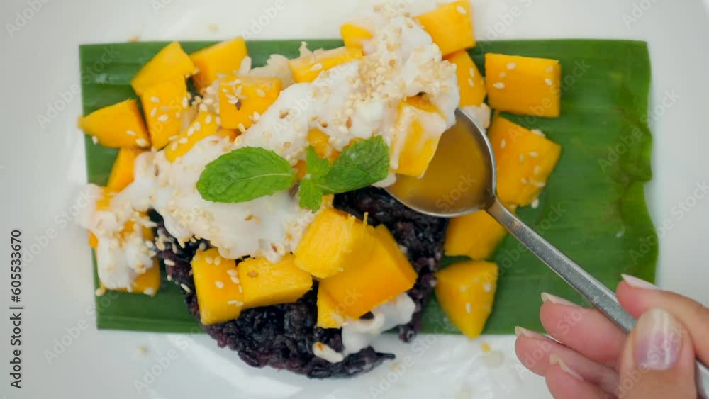 Top view of Thai mango sticky rice, delicious dessert made with fresh ...
