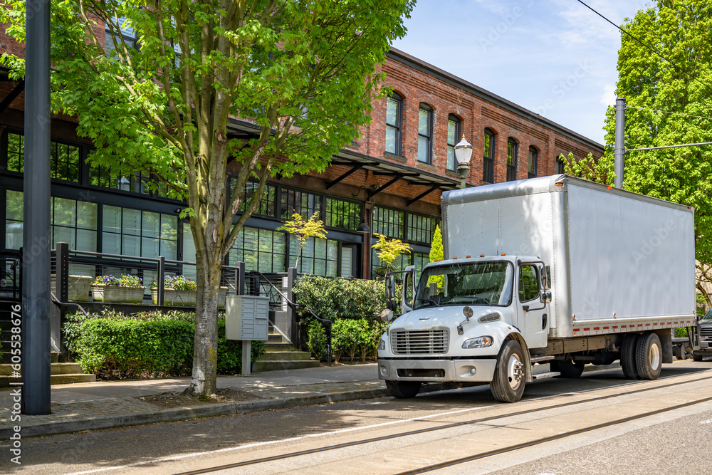 Moving business middle rig semi truck with big box trailer loading ...