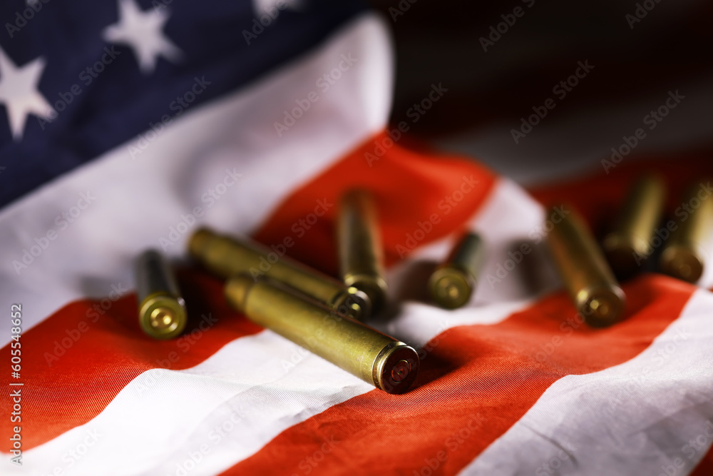 Many bullets cartridges and medals on United States flag. Concept of ...