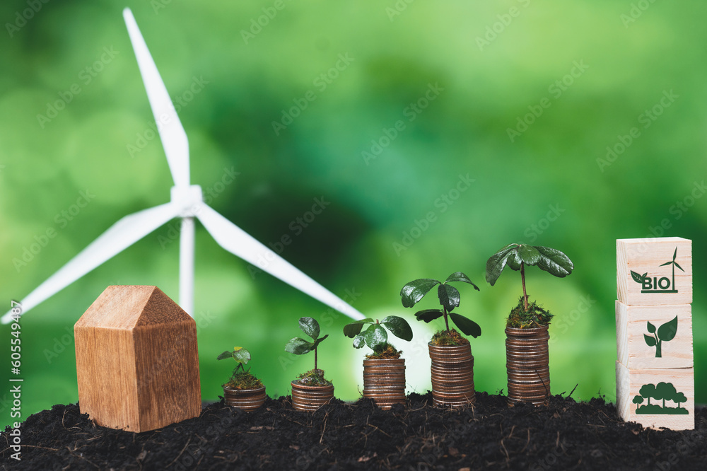Bio energy symbol with seedling on coin stack and wind turbine. Eco ...