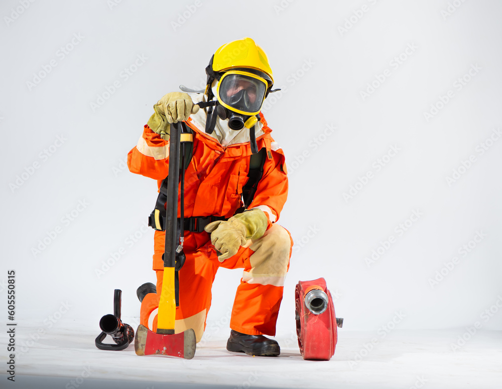 Professional firefighter is sitting and kneeling down on a white ...
